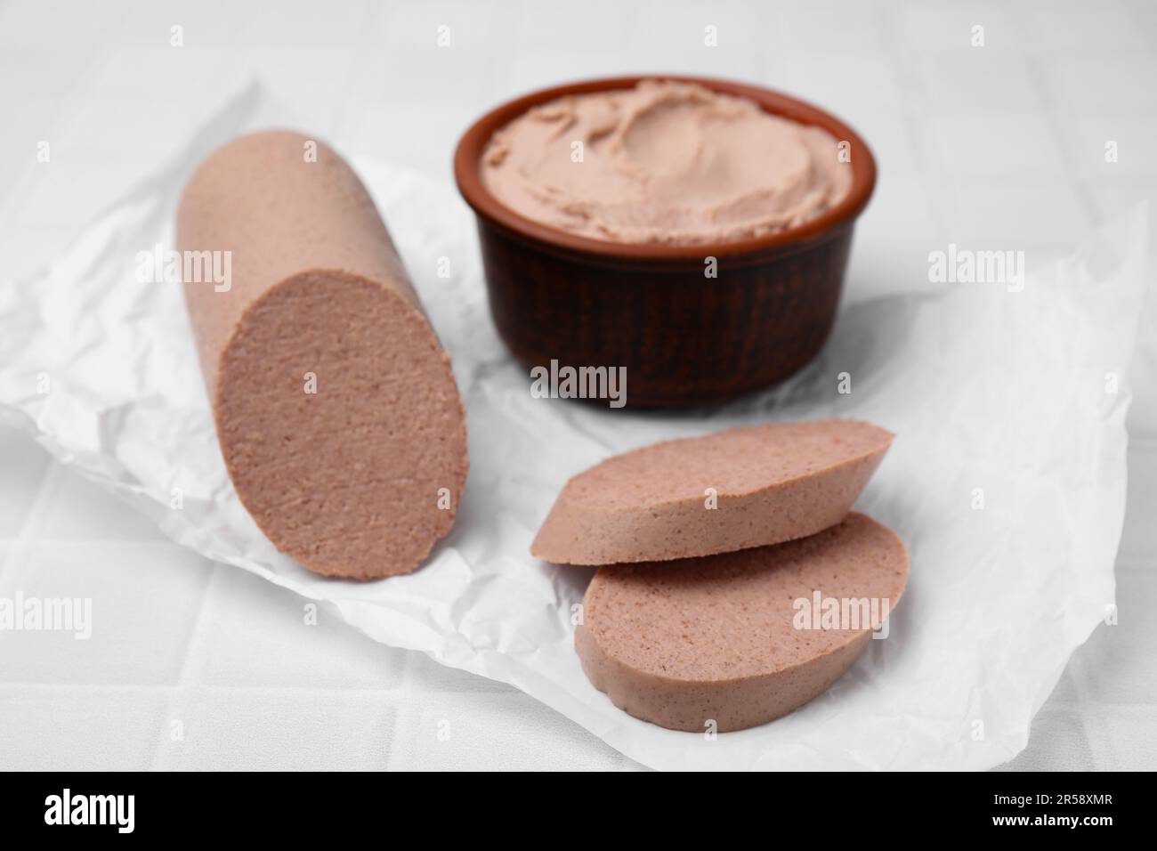 Delicious liver sausage and paste on white tiled table Stock Photo - Alamy