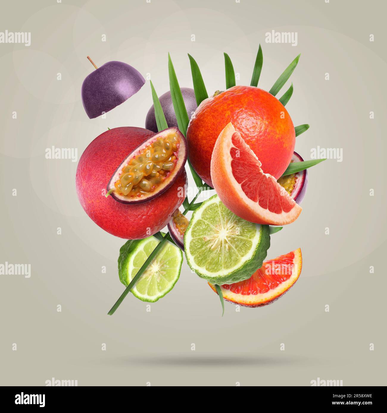 Many fresh tropical fruits falling on light background Stock Photo - Alamy