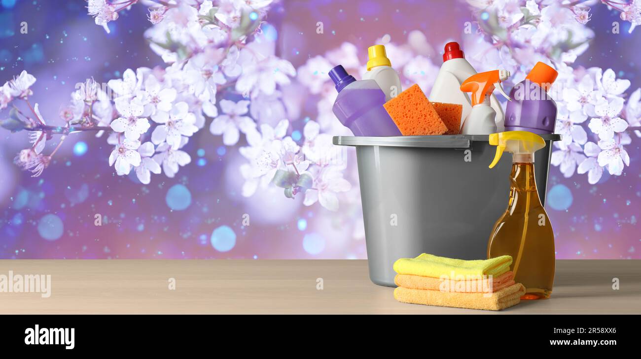 Spring cleaning. Bucket with detergents and tools on wooden surface ...