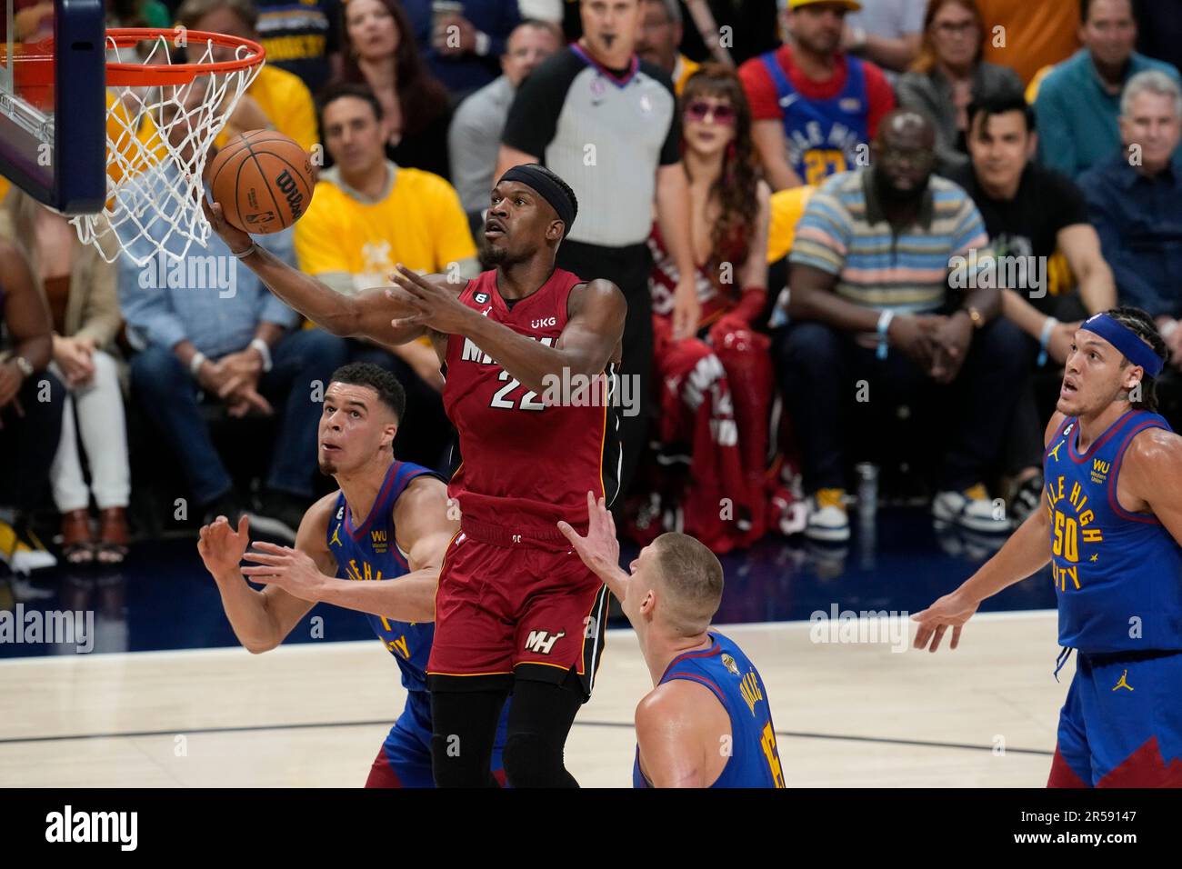 Miami Heat forward Jimmy Butler (22) shoots from between Denver Nuggets ...
