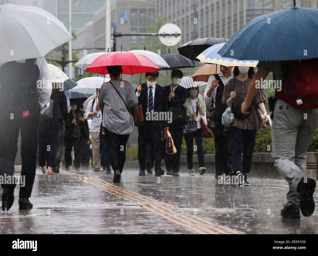 People having umbrellas go to their office while raining during ...