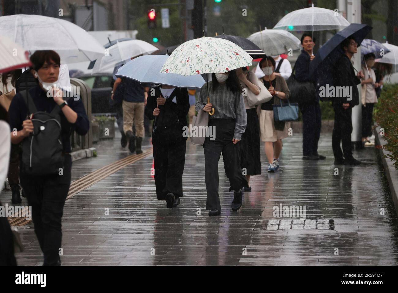People having umbrellas go to their office while raining during ...