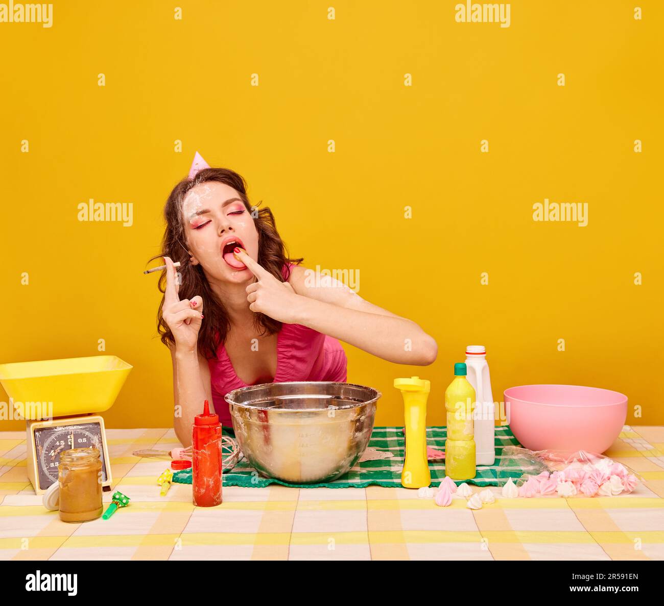 Young beautiful girl with bright makeup eating cake, cooking and ...