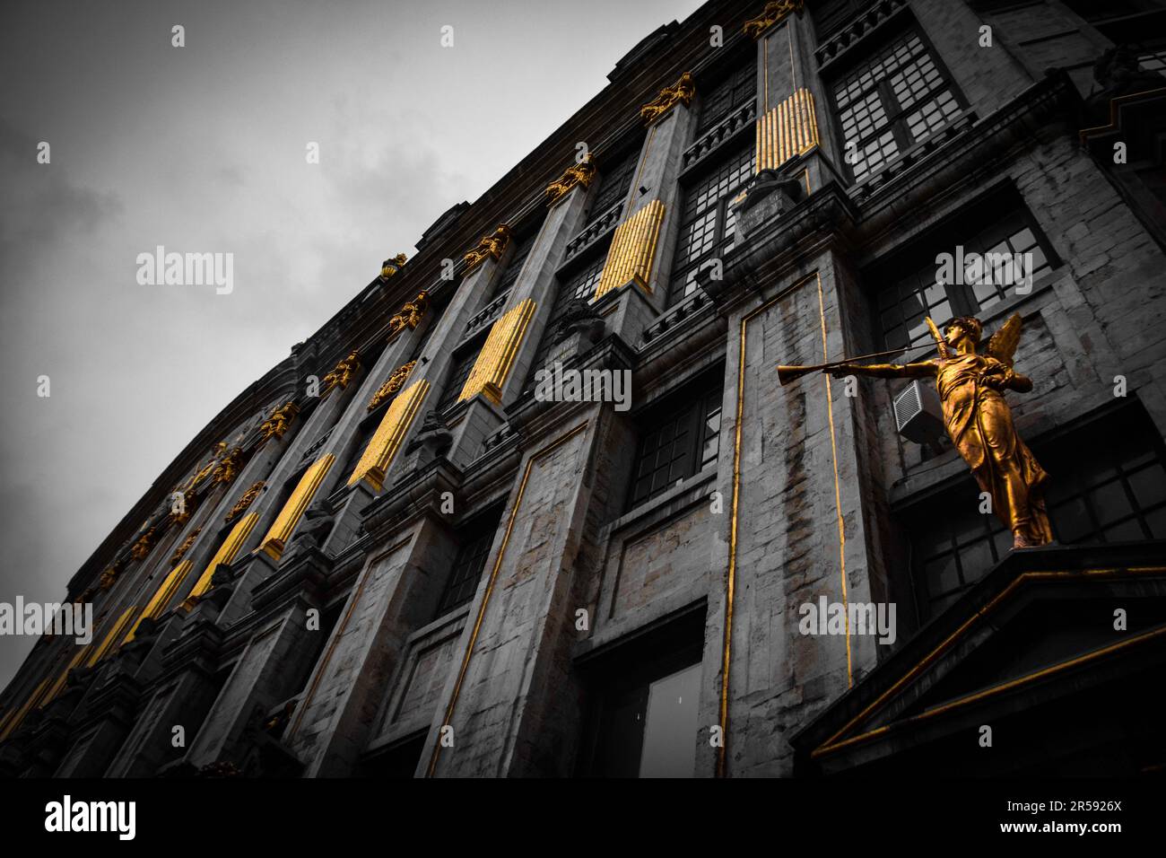 Selective Color Shot of a Golden Angel Sculpture in front of a ...