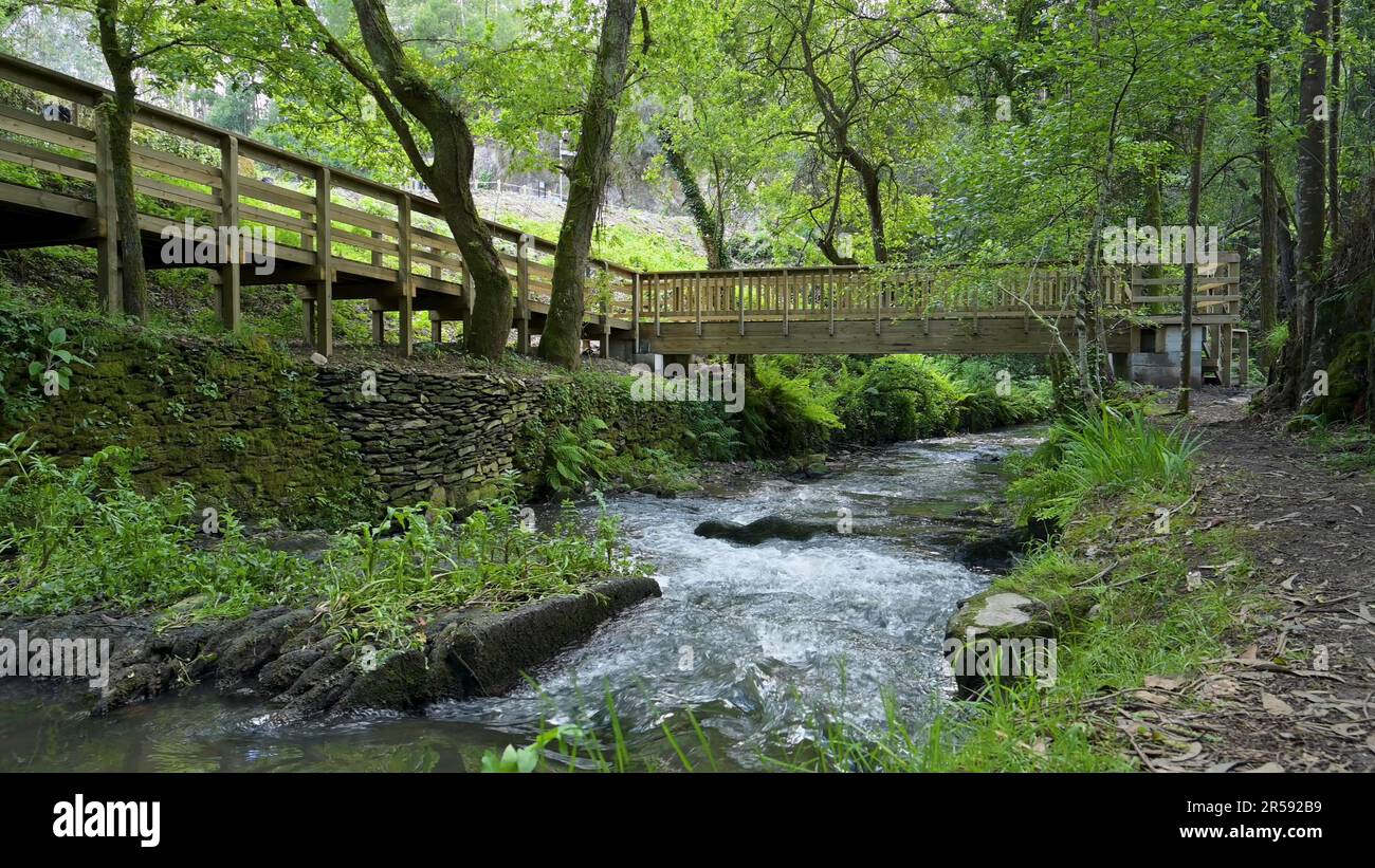 Surrounding landscape of the Estanislau fountain park and the Lourido river that divides the ...