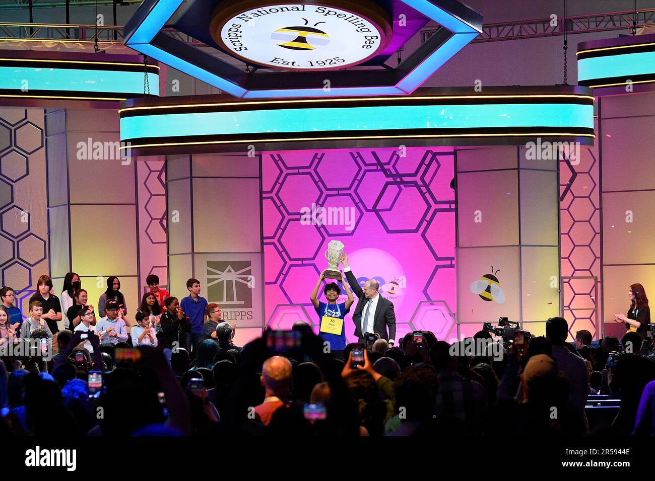 Dev Shah, 14, from Largo, Fla., lifts the trophy next to Scripps CEO ...