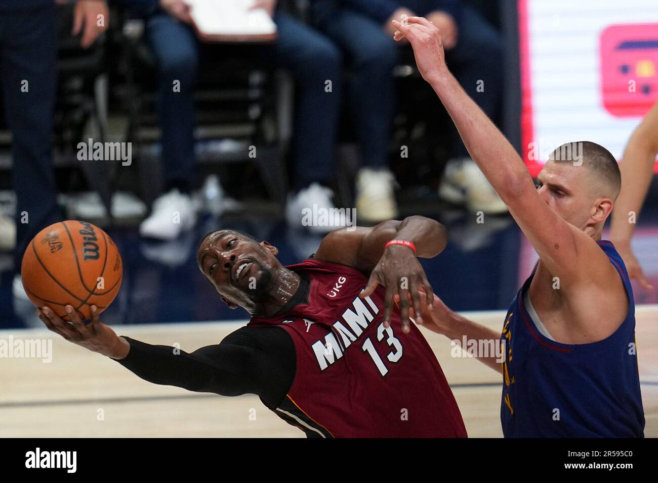 Miami Heat center Bam Adebayo, left, and Denver Nuggets center Nikola ...