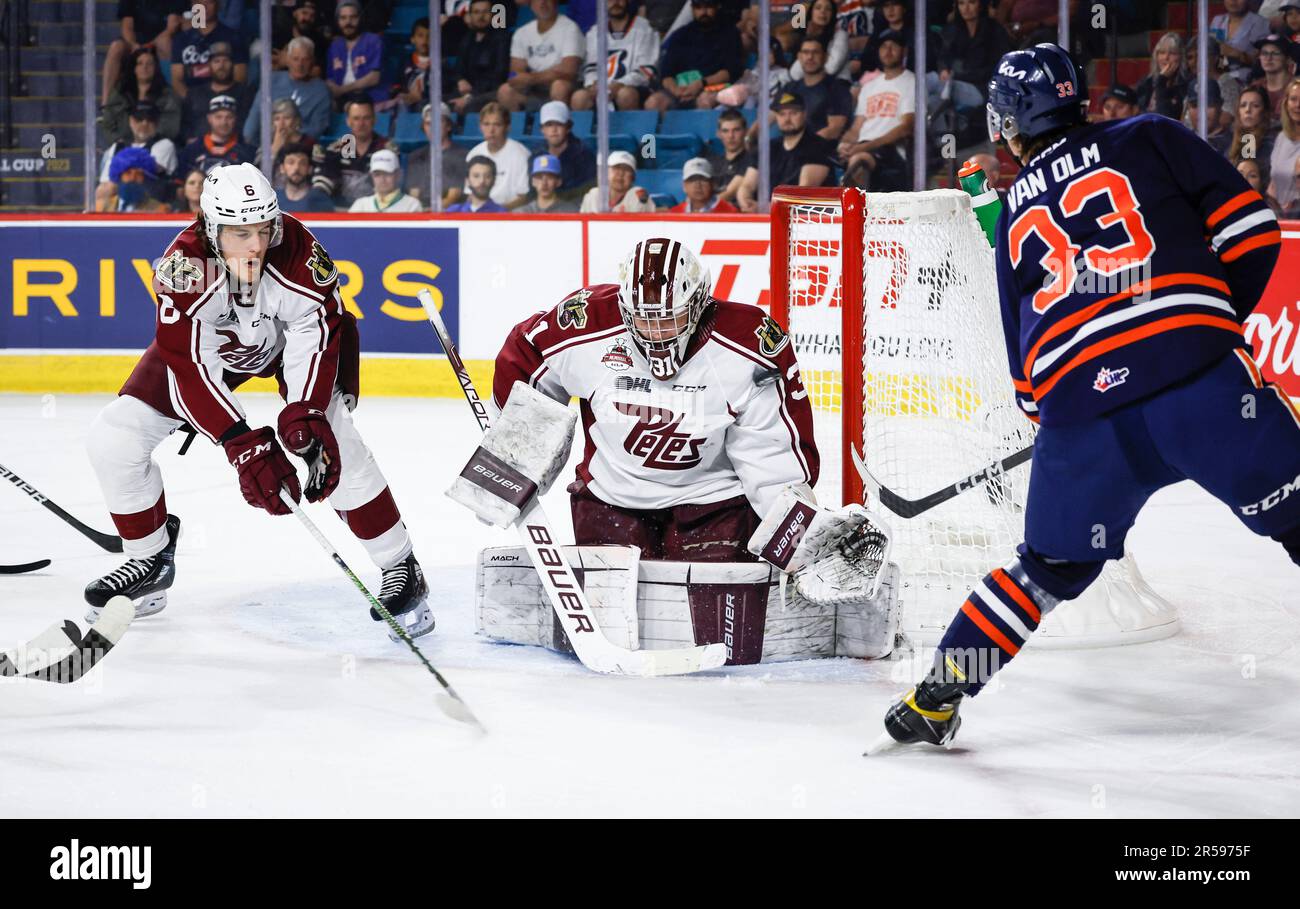 Peterborough Petes goalie Michael Simpson, center, stops a shot from ...
