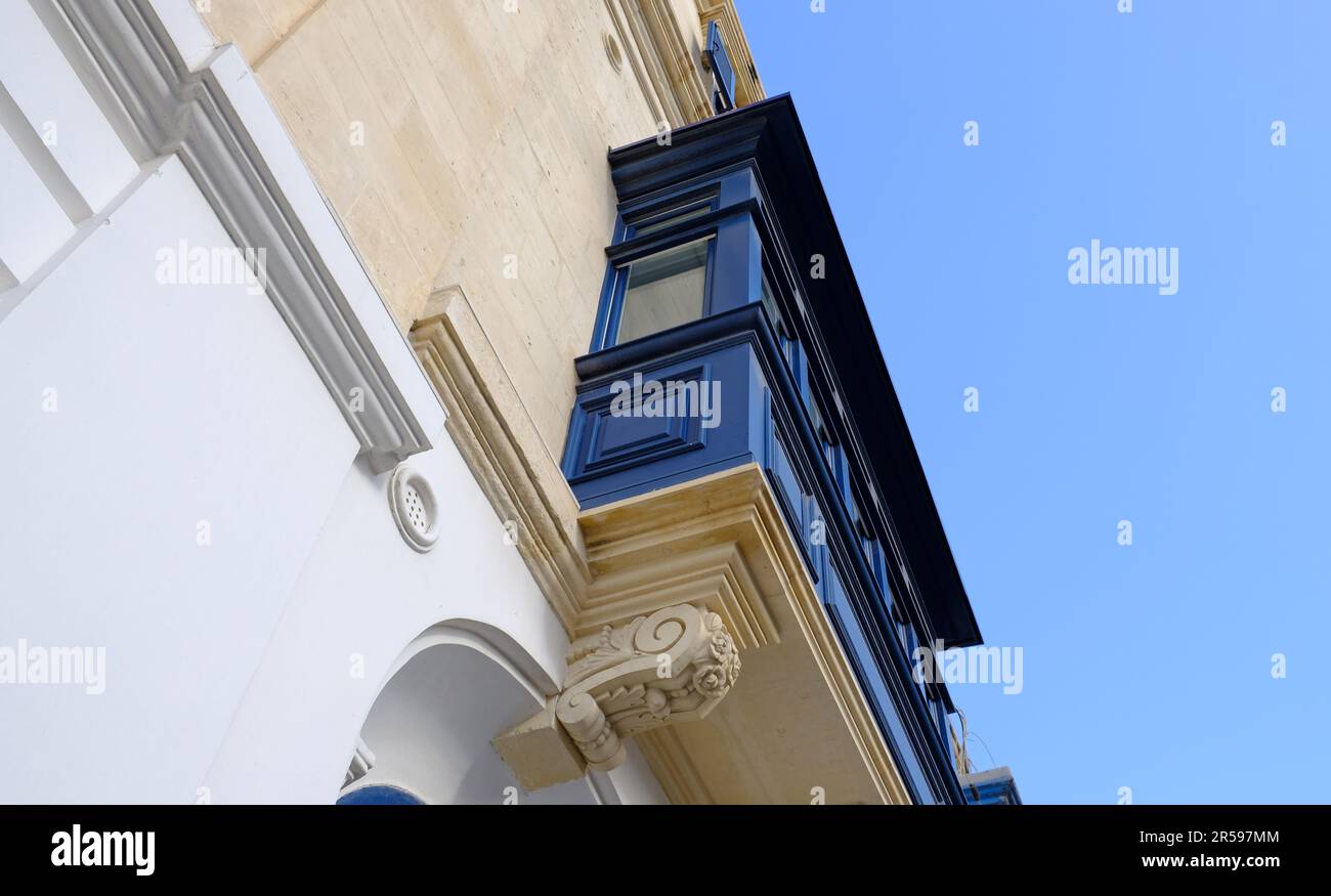 Bottom up view of typical maltese houses with blue wooden balcony with ...
