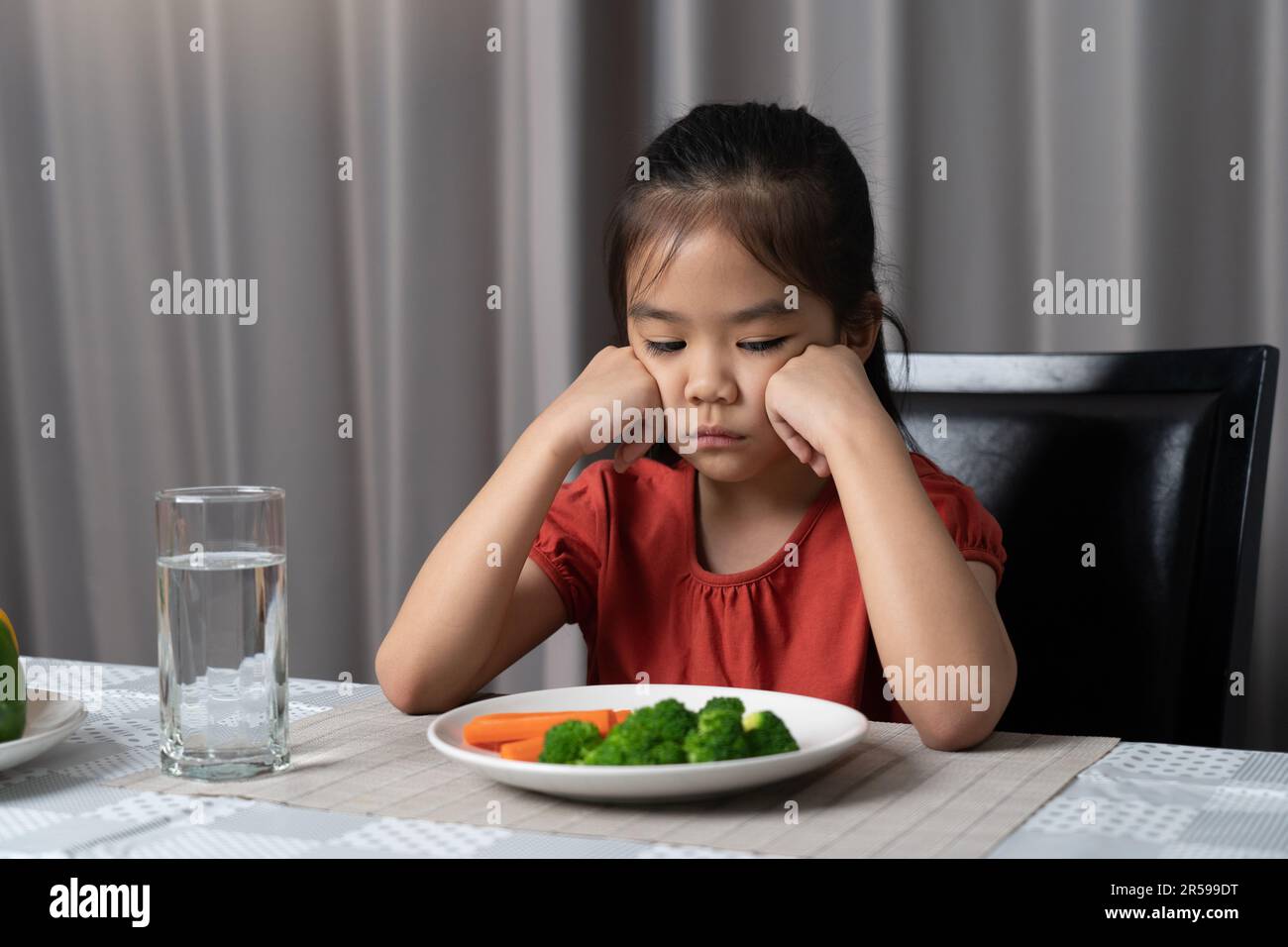 Little cute kid girl refusing to eat healthy vegetables. Children do ...