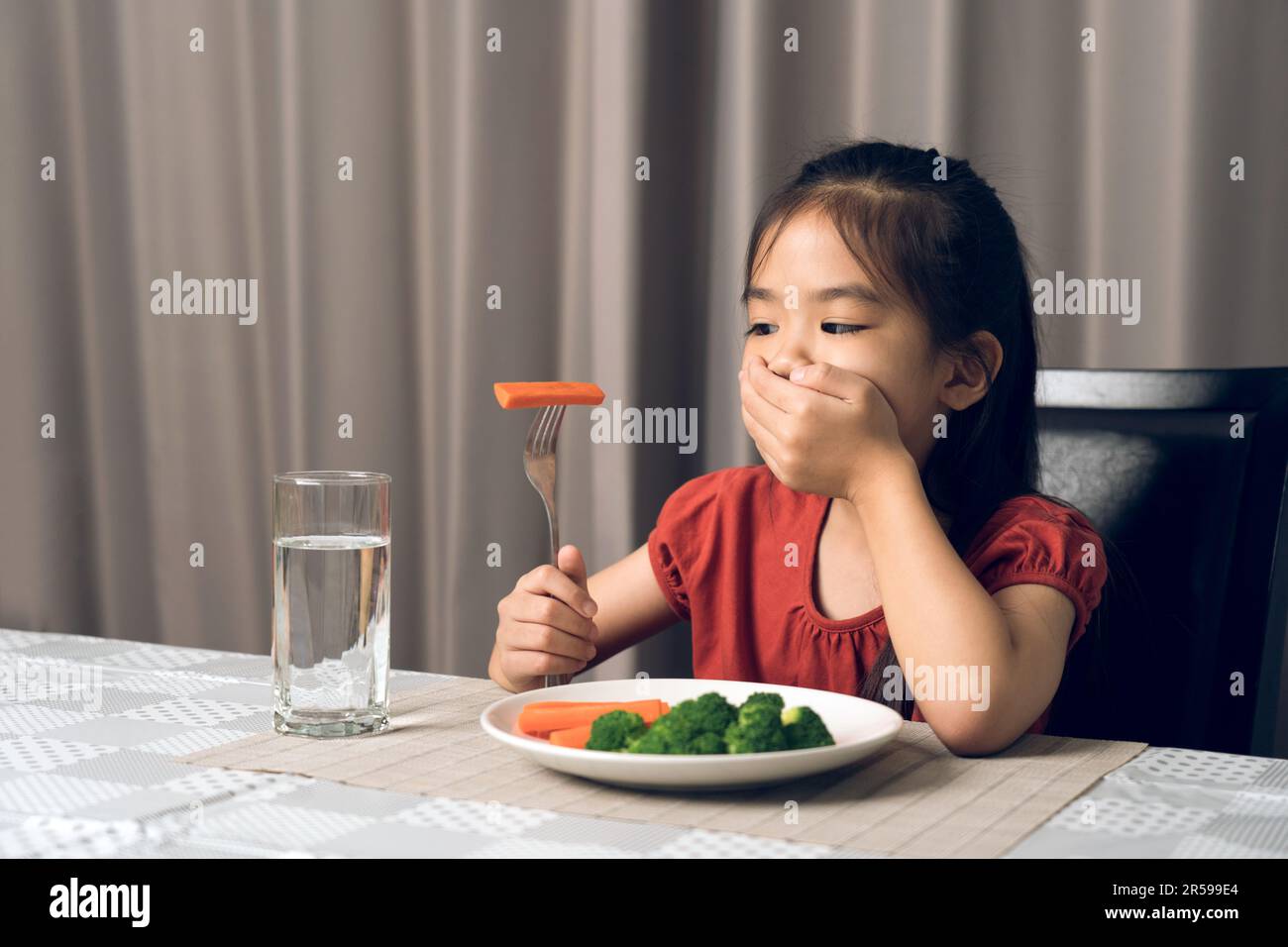 Little cute kid girl refusing to eat healthy vegetables. Children do ...
