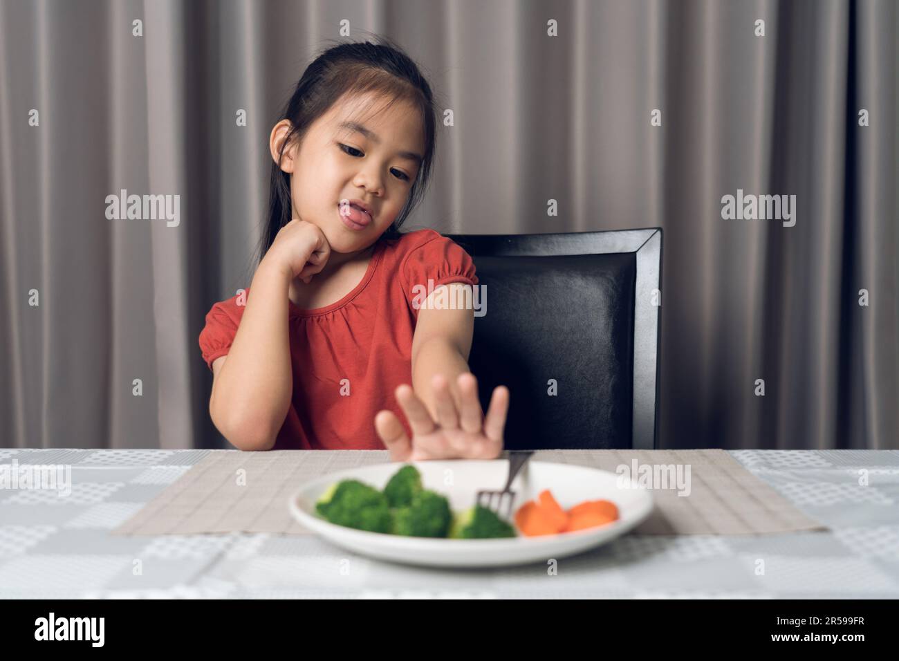 Little cute kid girl refusing to eat healthy vegetables. Children do ...