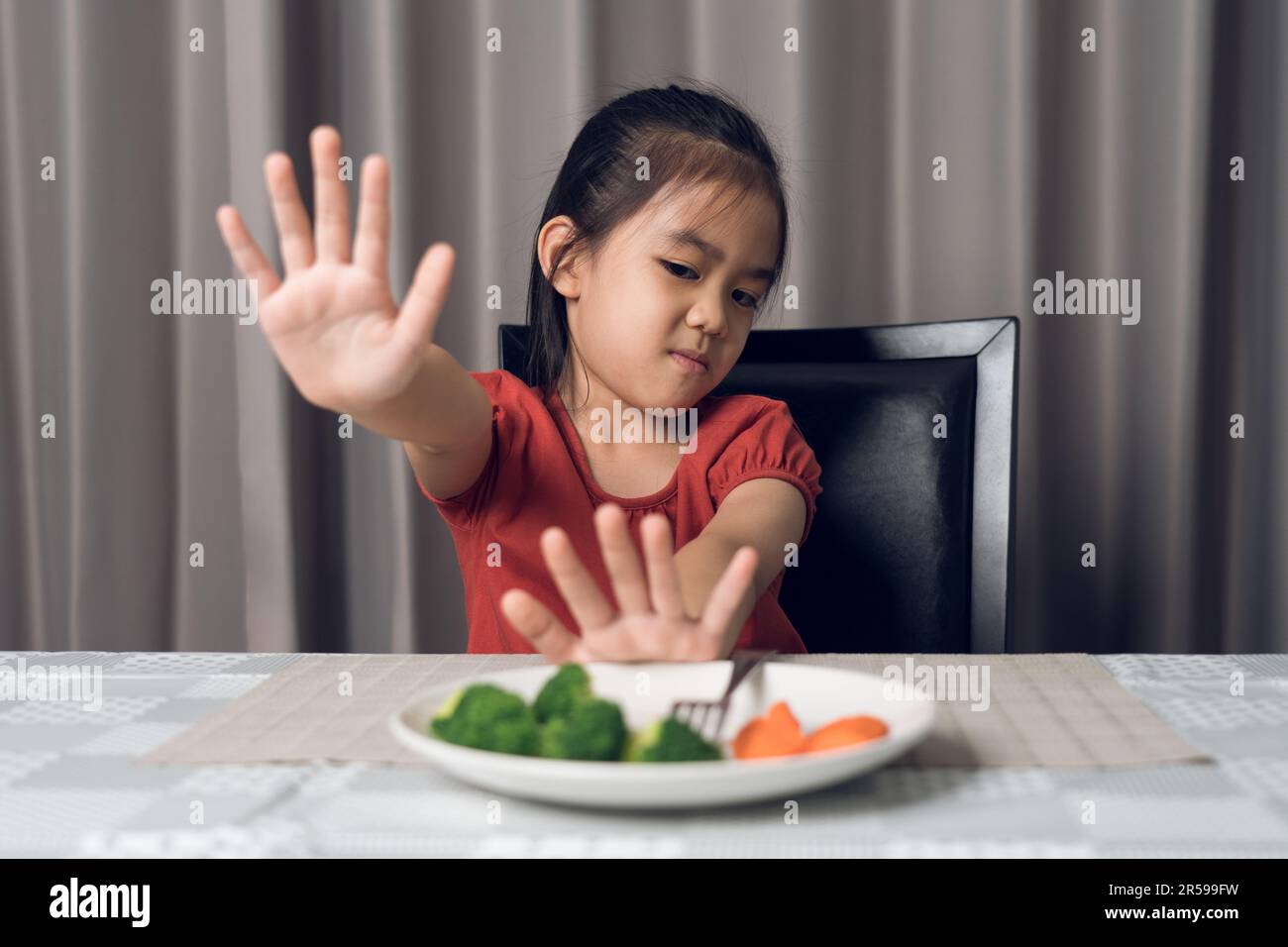 Little cute kid girl refusing to eat healthy vegetables. Children do ...
