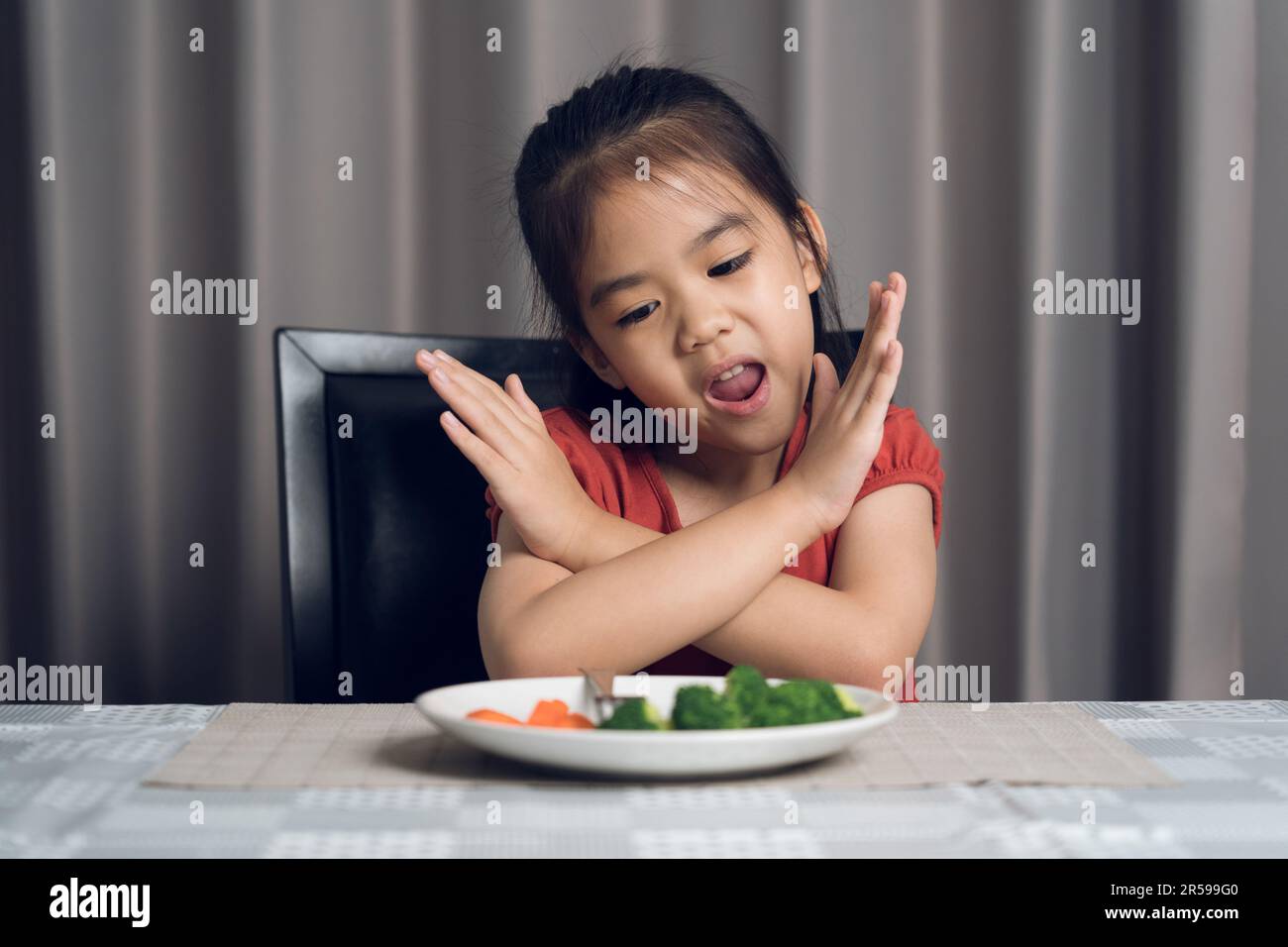 Little cute kid girl refusing to eat healthy vegetables. Children do ...