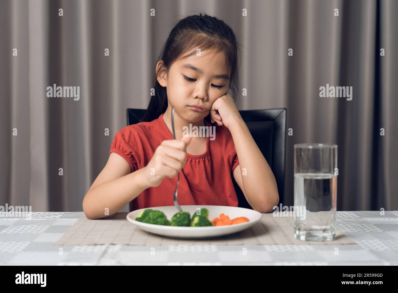 Little cute kid girl refusing to eat healthy vegetables. Children do ...