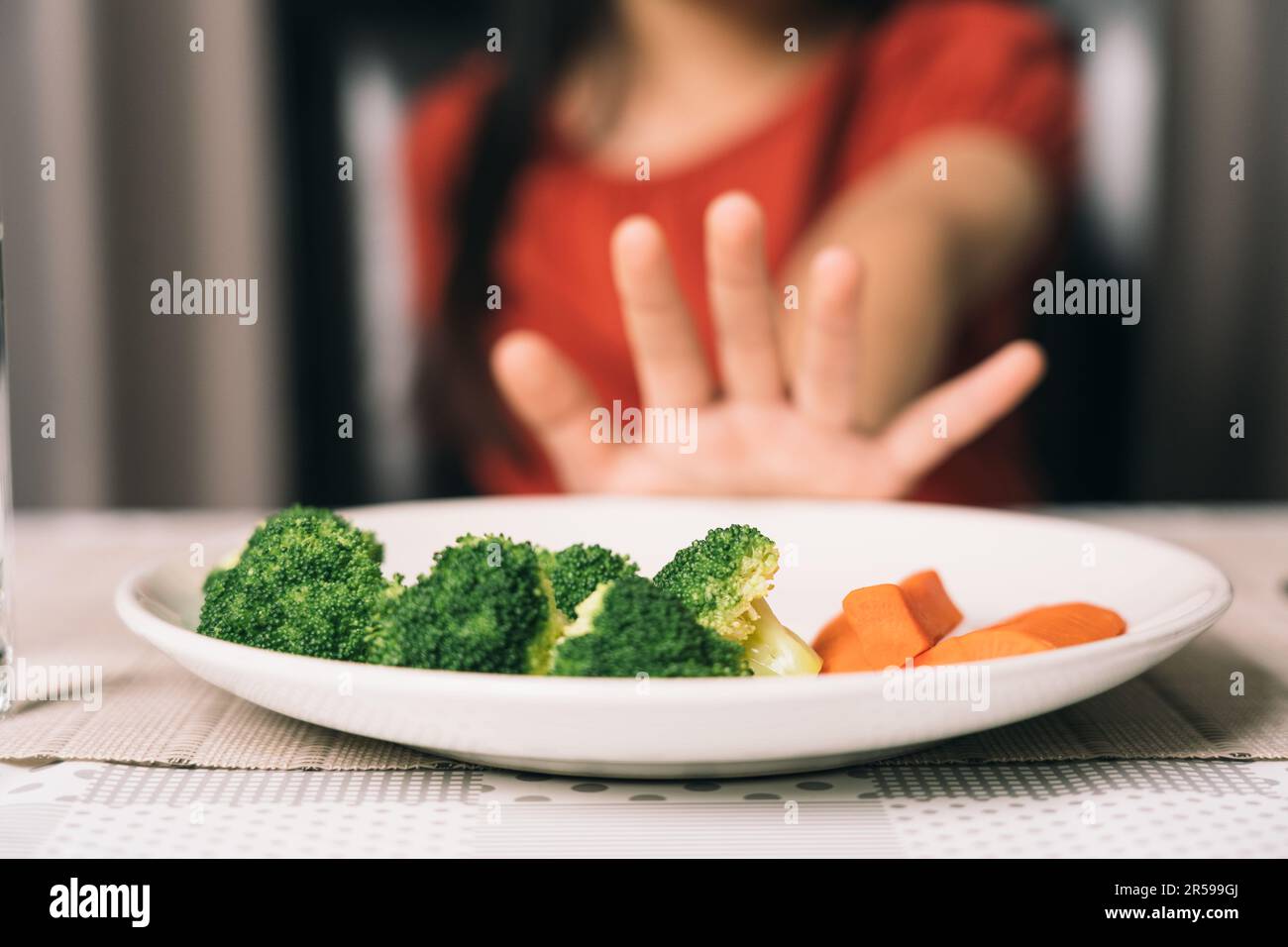 Little cute kid girl refusing to eat healthy vegetables. Children do ...