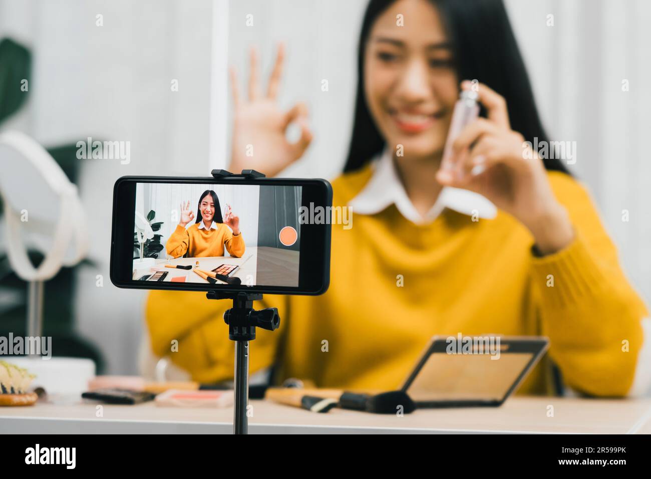 Asian teenage girls doing makeup vlogs and using a video mobile camera ...