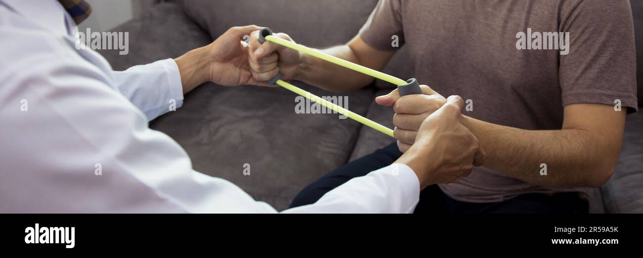 Asian male physical therapist descent working and helping to protect ...