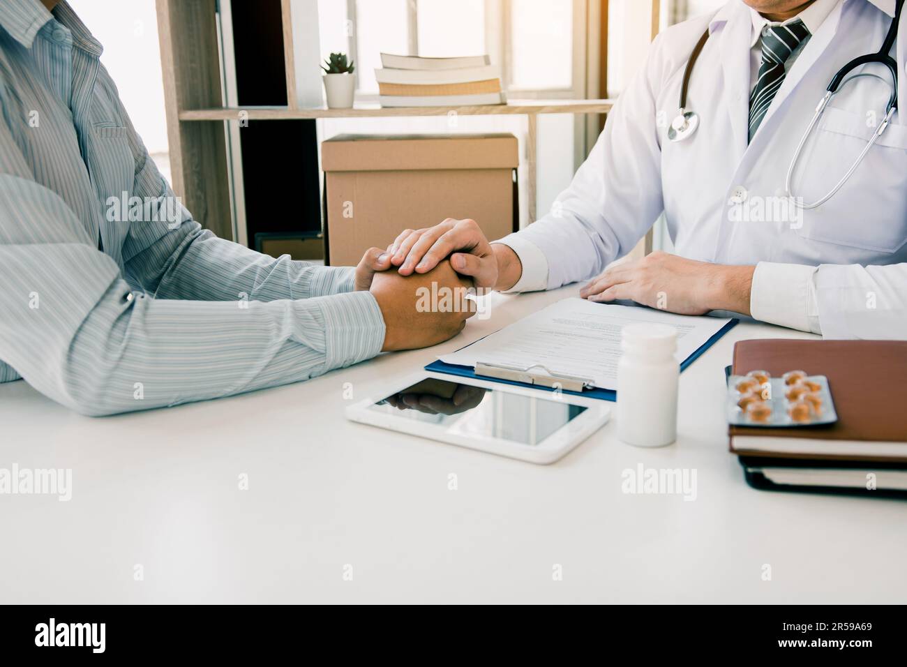 The doctor shook hands and consoled the patients who were worried about ...