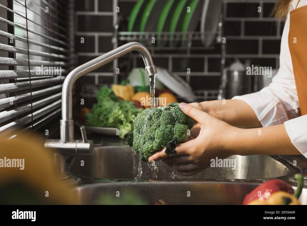 Asian hands woman washing vegetables broccoli and preparation healthy ...