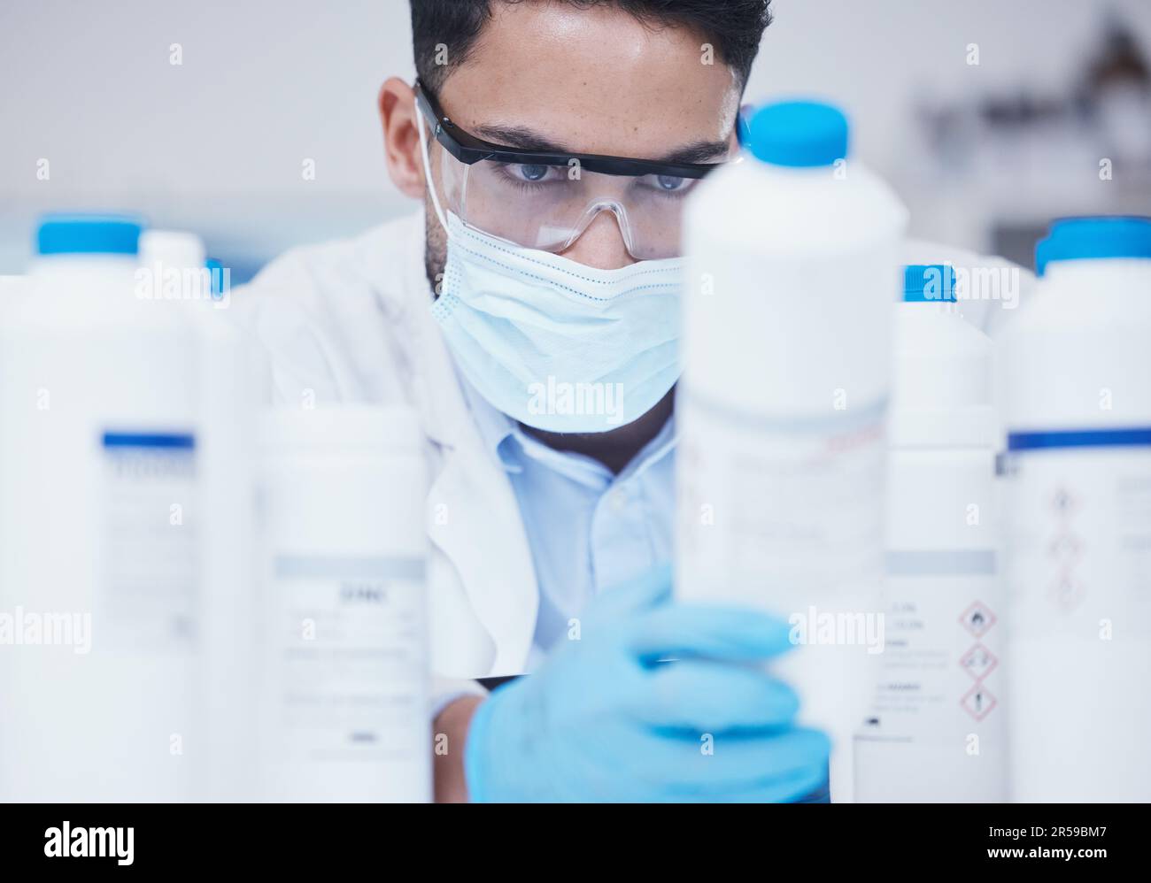 Stock check, chemical bottle and man scientist with mask at ...