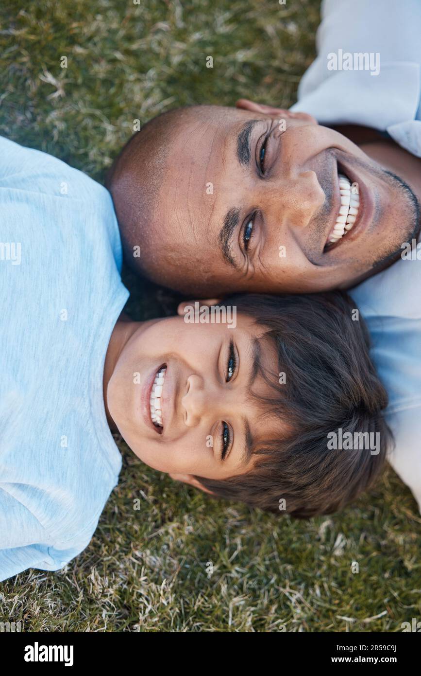 Family, portrait and lying on grass in backyard with father and kid ...