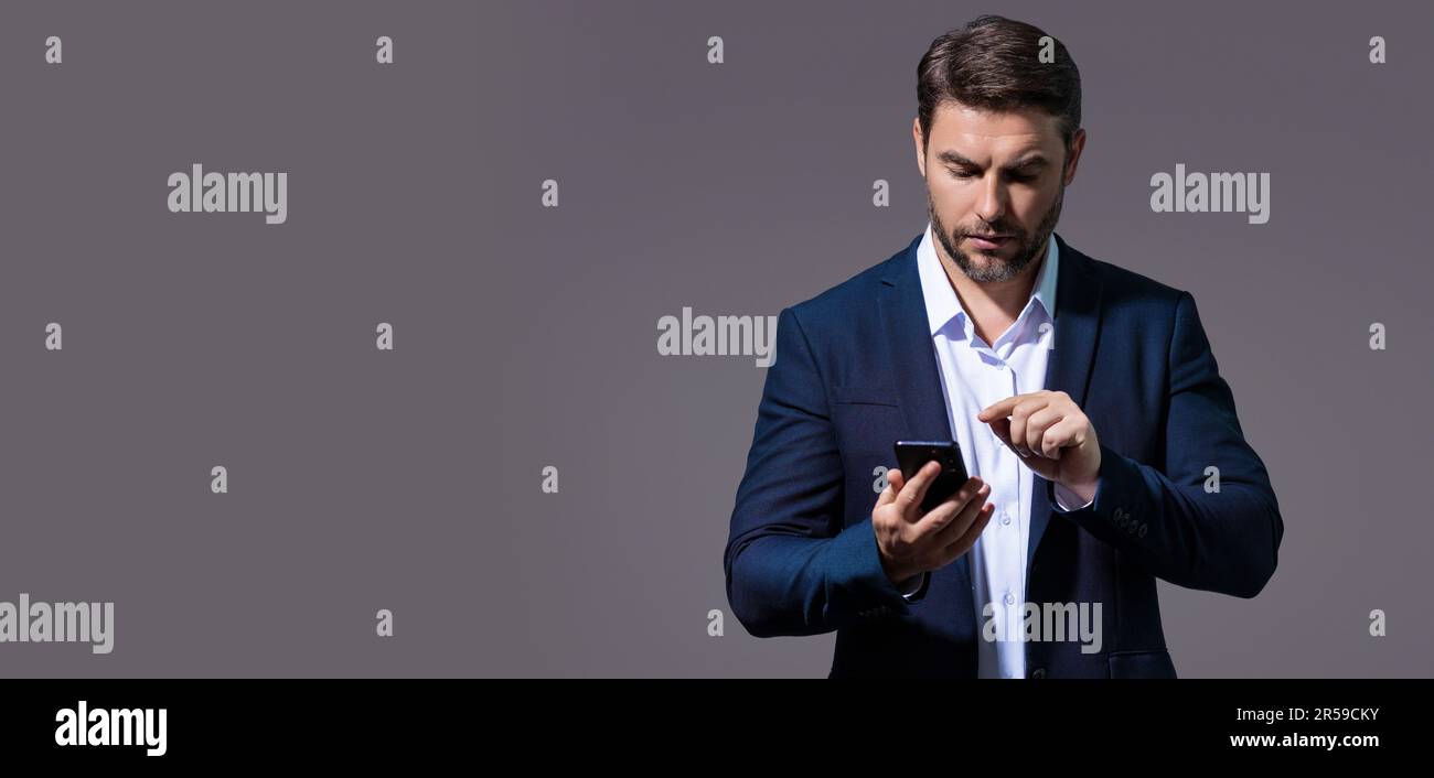 European business man in formal suit watching on mobile phone. Handsome ...
