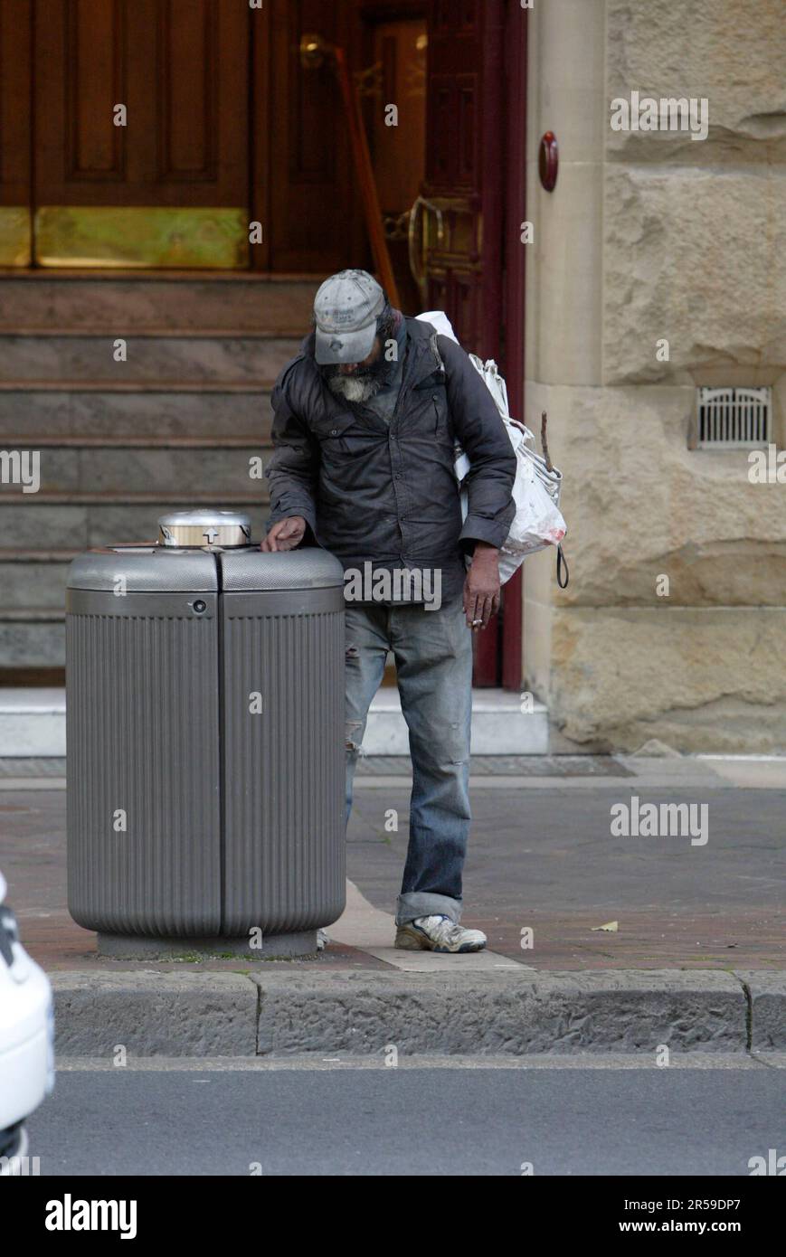 A homeless man rummages through a garbage bin on Macquarie Street in ...