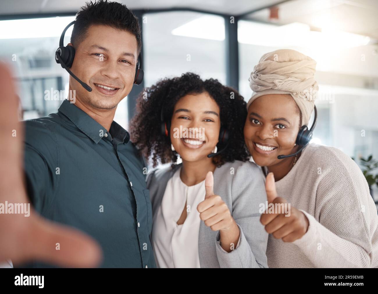 Selfie, thumbs up and call center friends in the office, posing for a ...