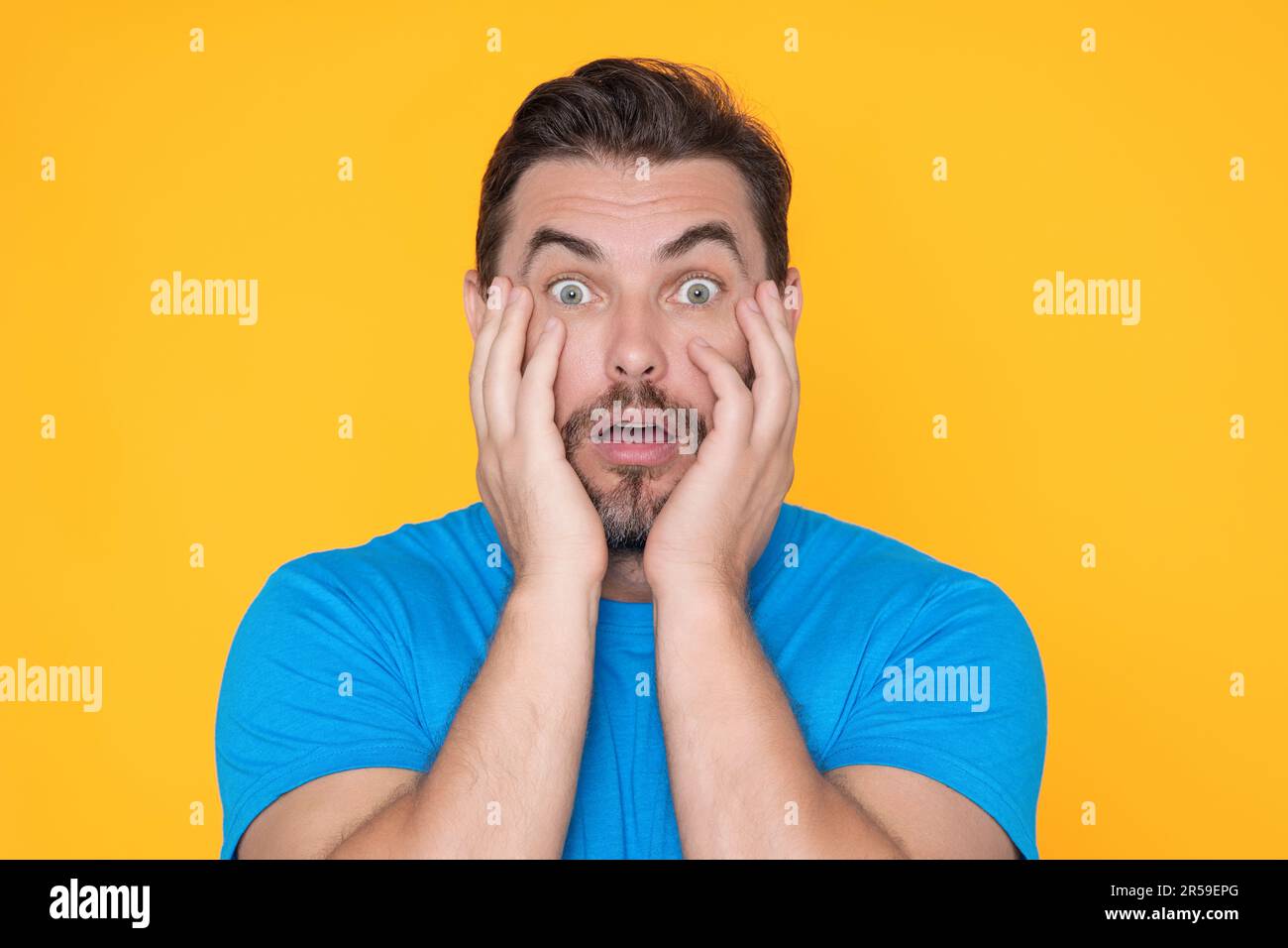 Handsome surprised man over isolated studio background afraid and ...