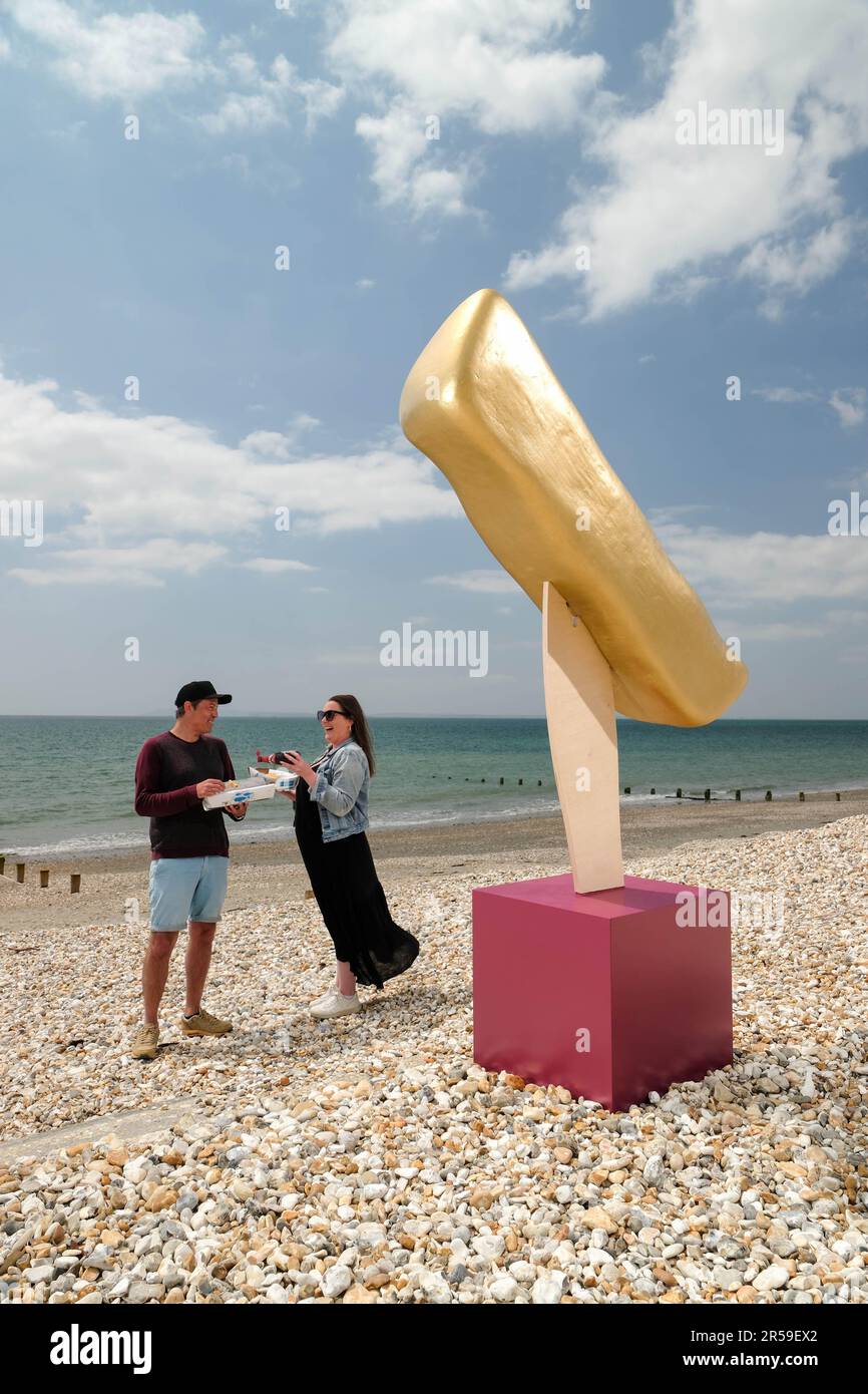 EDITORIAL USE ONLY A giant golden chip statue is installed by vinegar ...