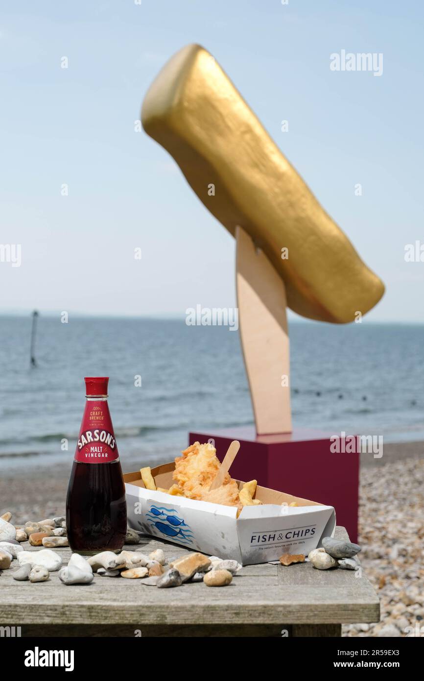 EDITORIAL USE ONLY A giant golden chip statue is installed by vinegar ...