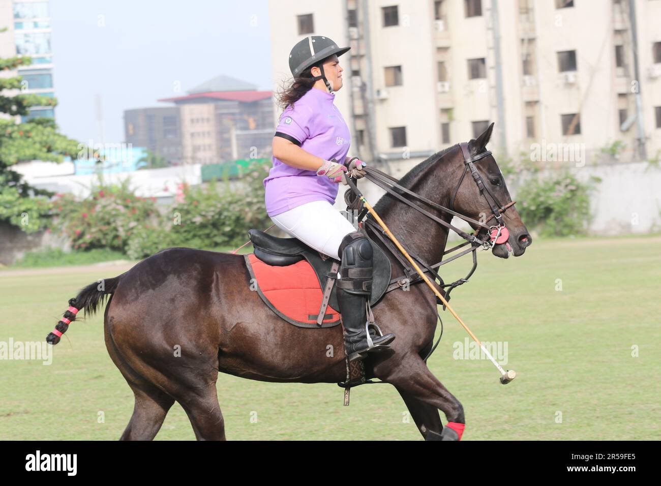 Polo players compete for the ball during the Ladies Polo invitation ...