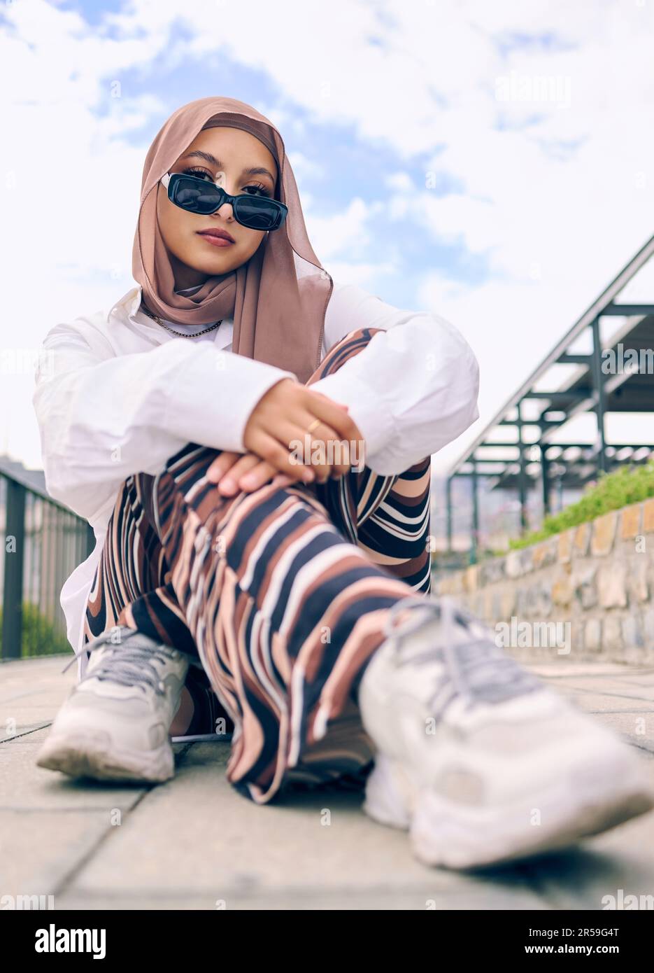 Portrait, fashion or hijab with an islam woman outdoor in sunglasses ...