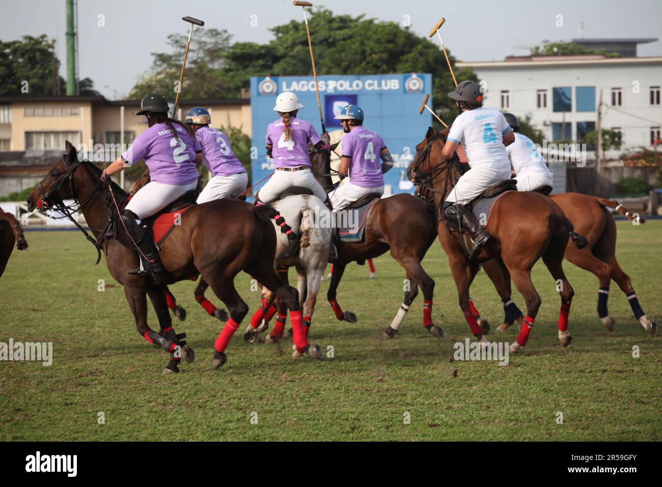 Polo players compete for the ball during the Ladies Polo invitation ...