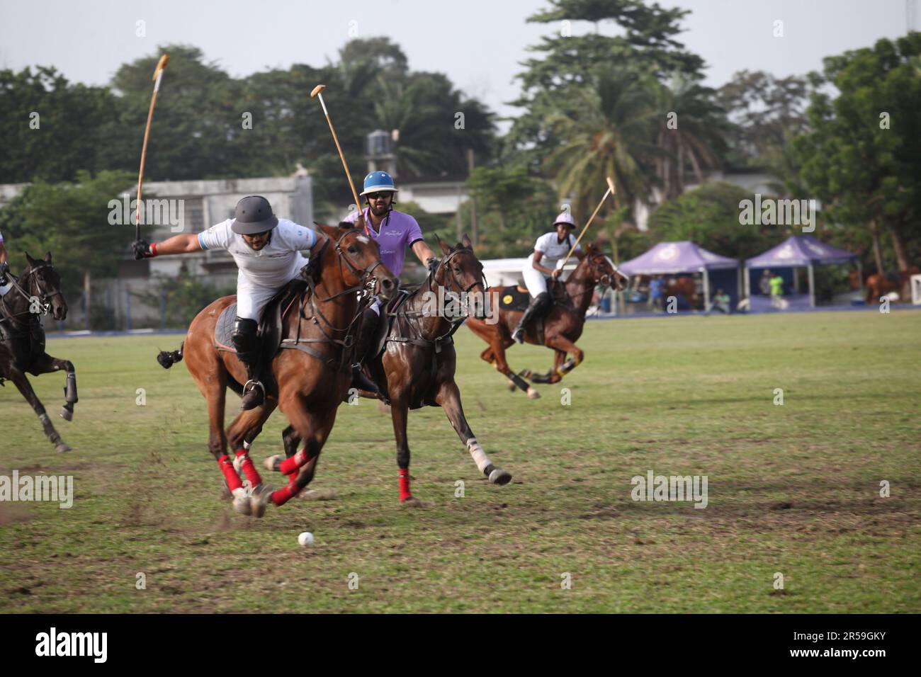 Polo players compete for the ball during the Ladies Polo invitation ...