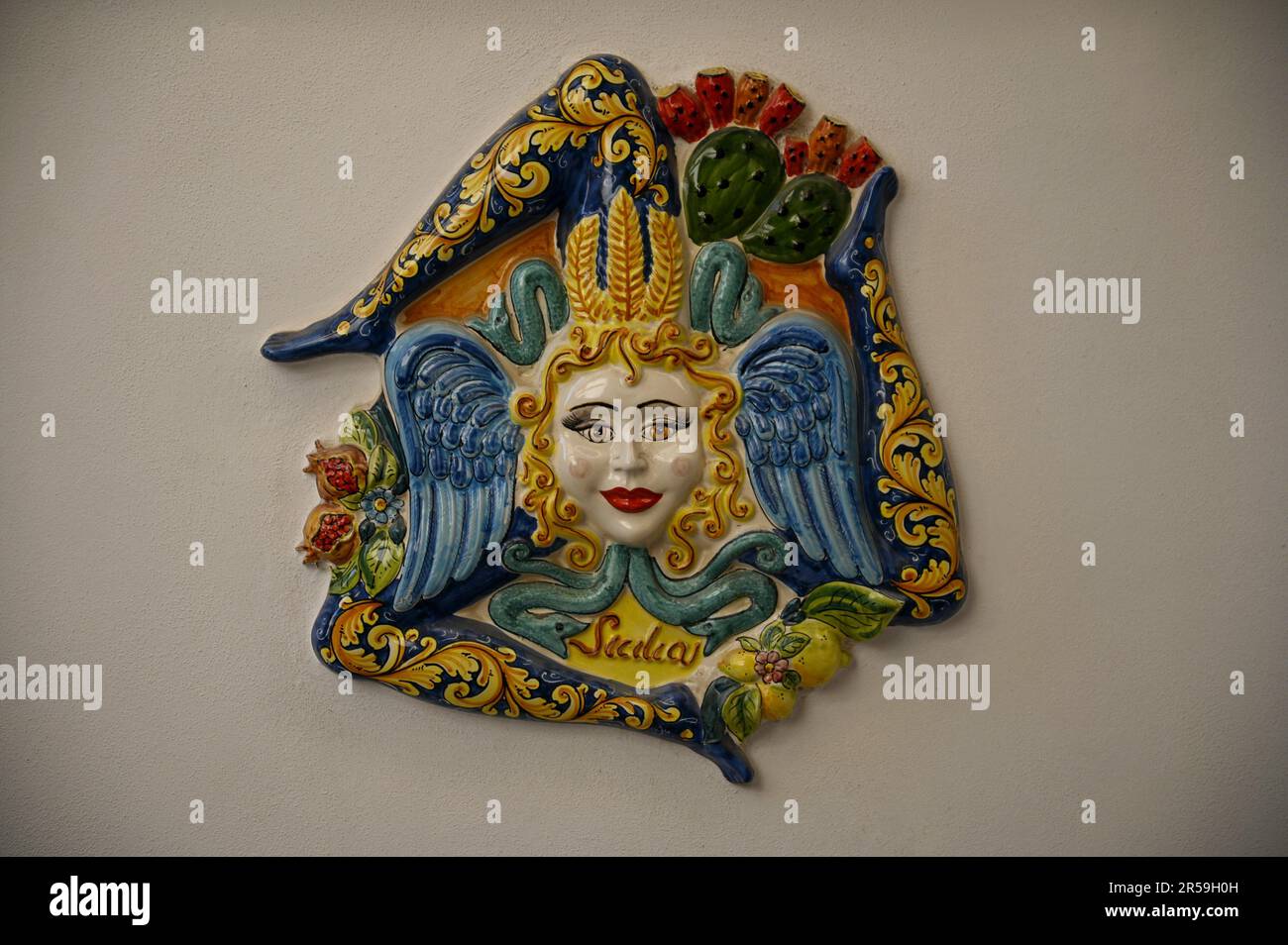Typical glazed ceramic sign with the Trinacria a Sicilian symbol at the ...