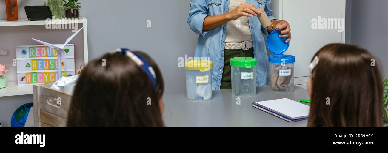 Unrecognizable teacher teaching how to recycle by sorting waste Stock ...