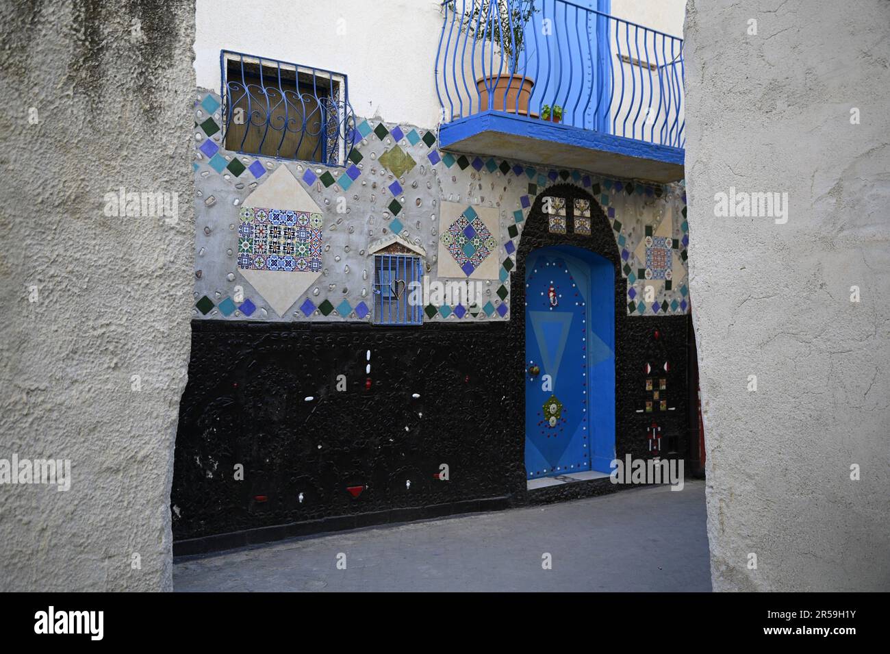 Typical house on Via Pilazza with a striking blue entrance door at the ...