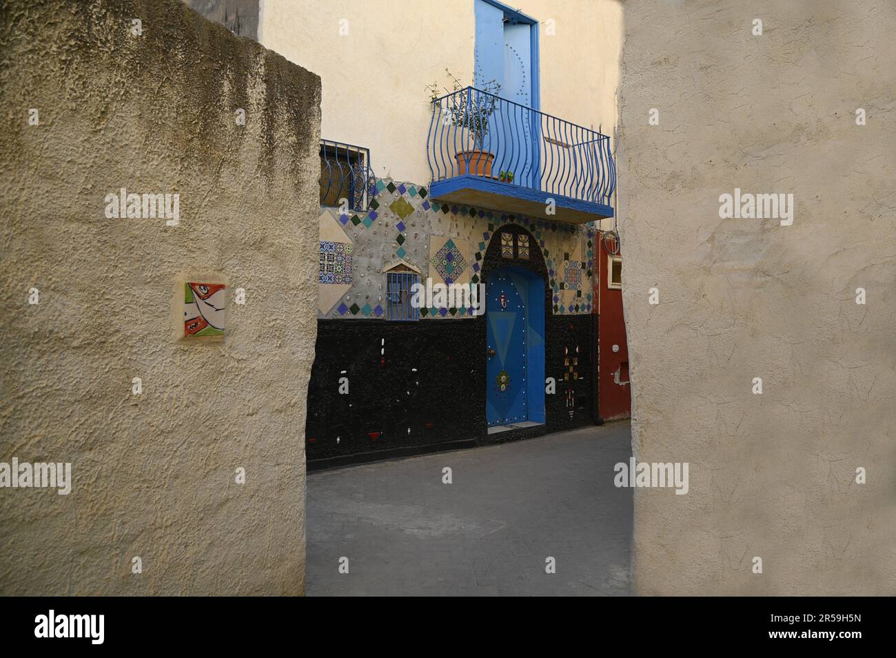 Typical house on Via Pilazza with a striking blue entrance door at the ...