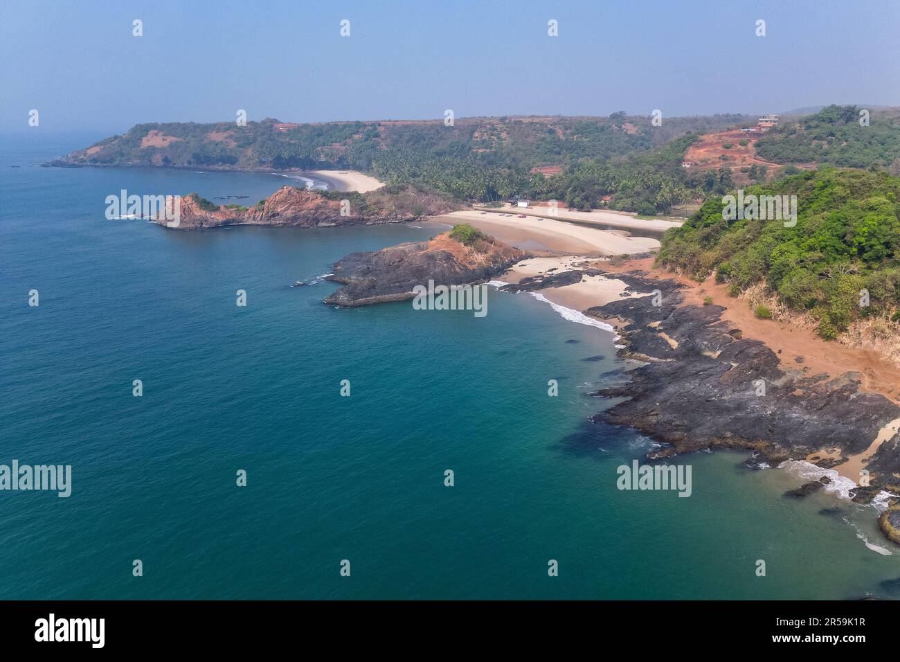 Aerial top view on tropical beach with green palm trees under sunlight ...