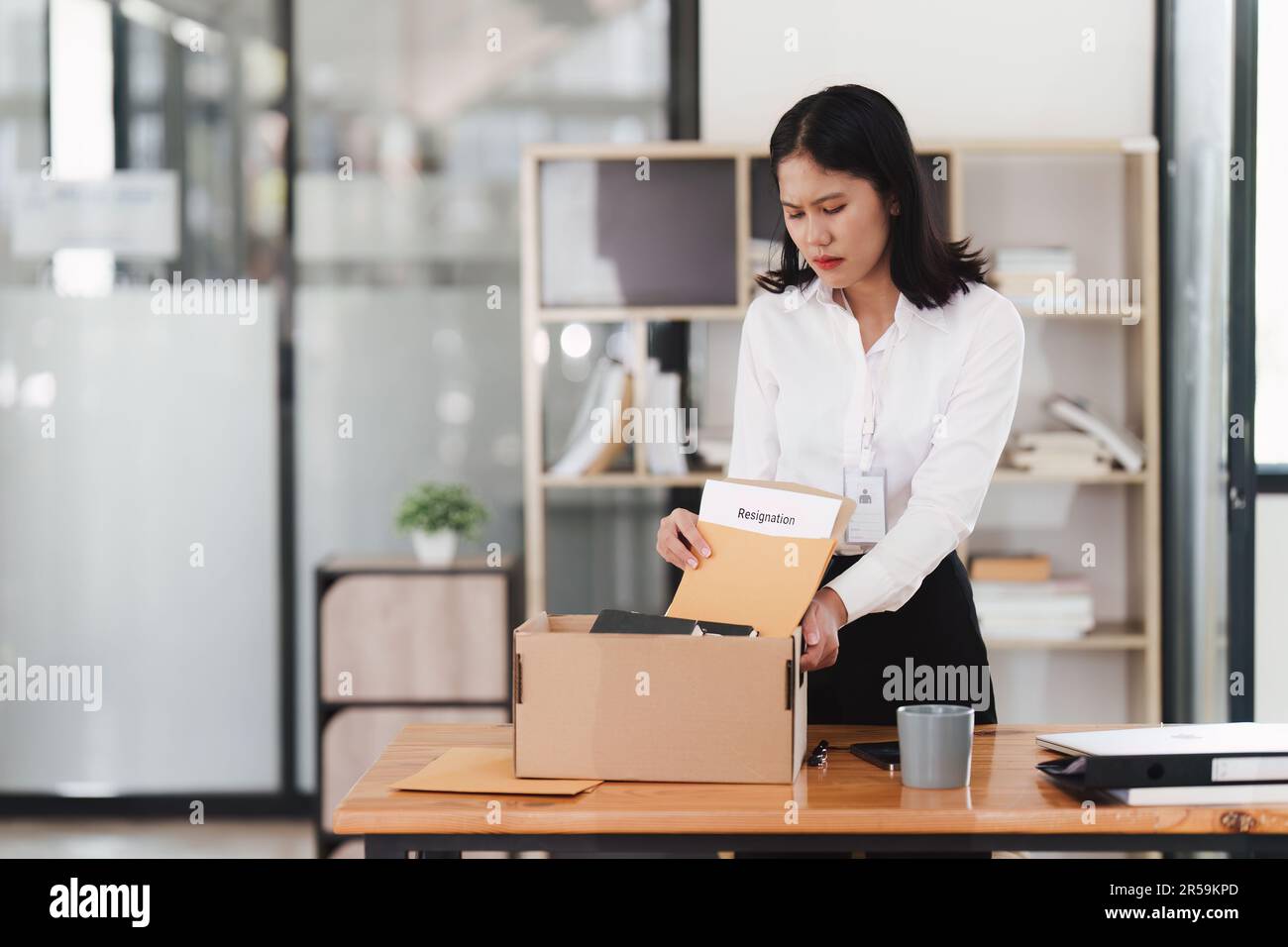 Resignation concept. Fired employee holding box of belongings in an ...