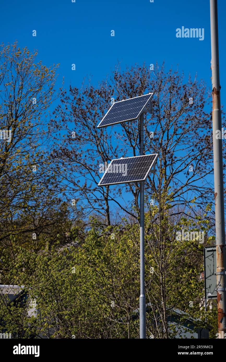 Two solar cell panels on a pole Stock Photo - Alamy