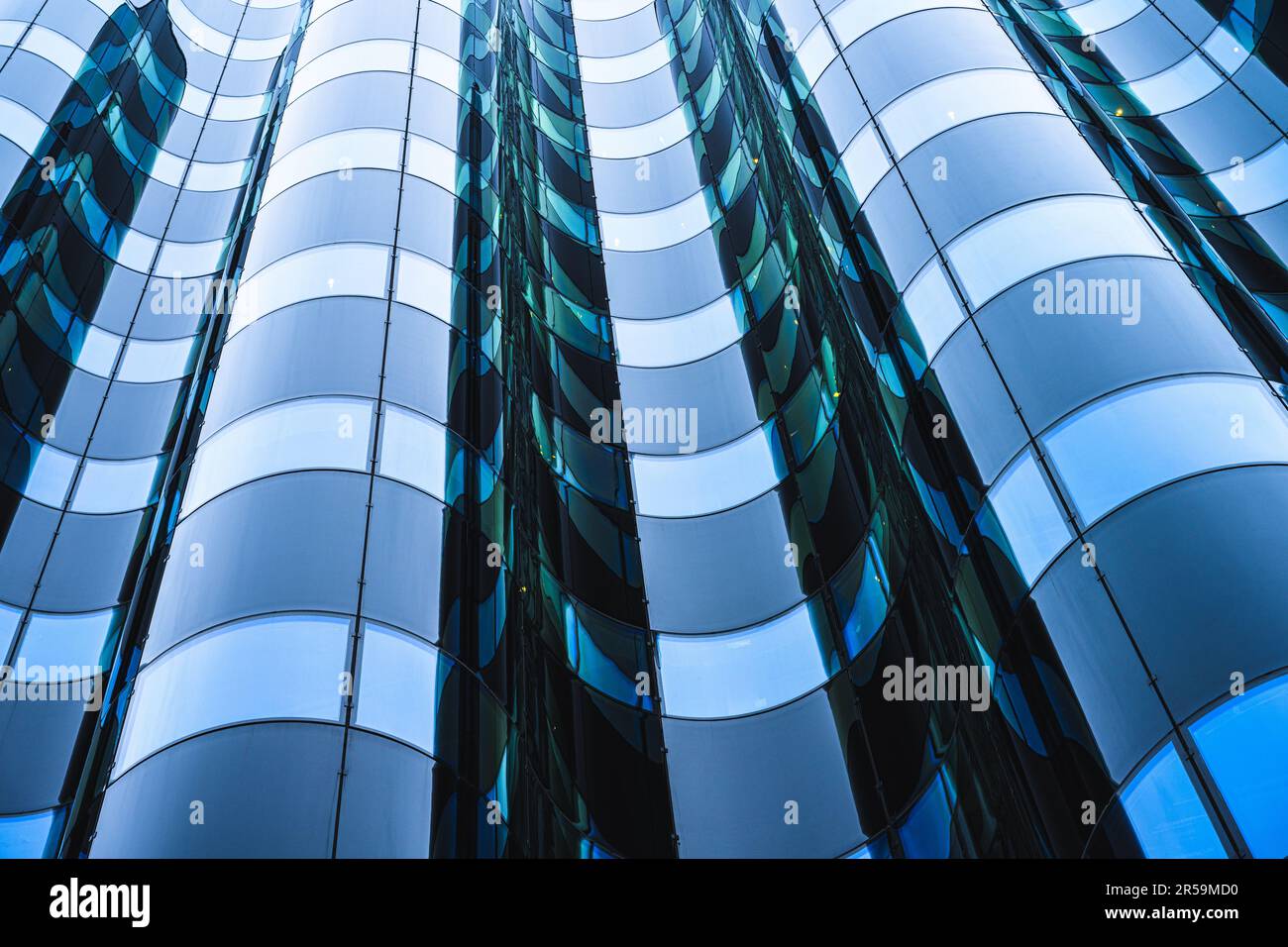 Wave formed glass facade of an office building Stock Photo - Alamy