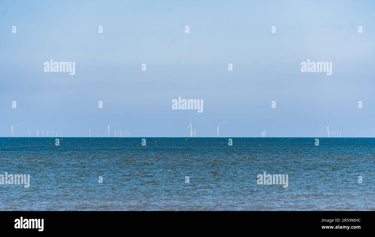 Many wind turbines at sea visible in the horizon. Transformation ...