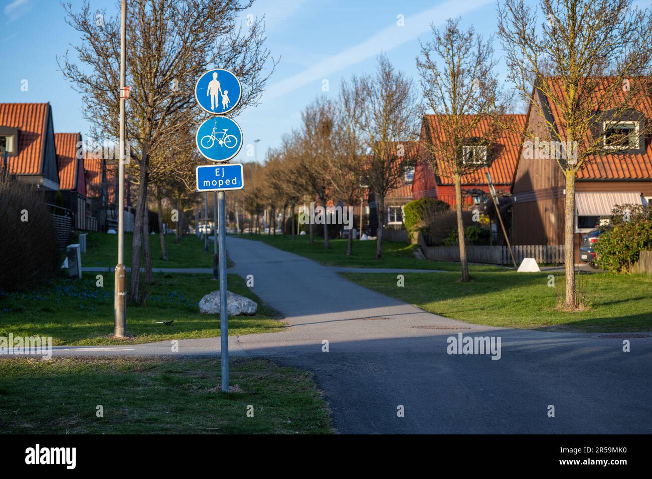 Walking and bike lane between identical houses Stock Photo - Alamy
