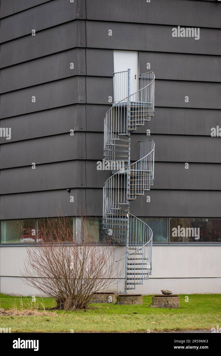 Winding rescue stairs on the facade of a warehouse Stock Photo - Alamy