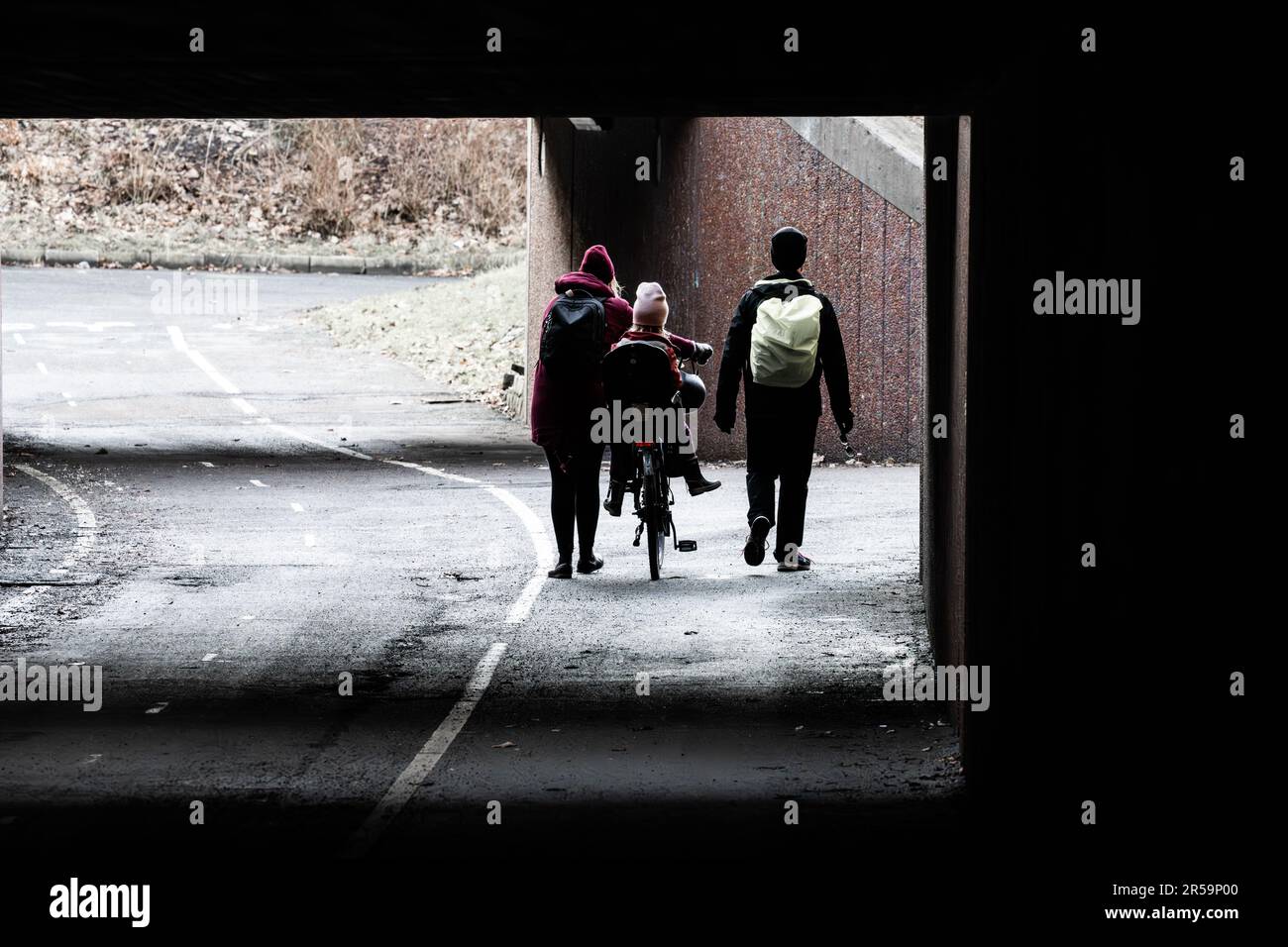 Small family walking through a walking tunnel Stock Photo - Alamy