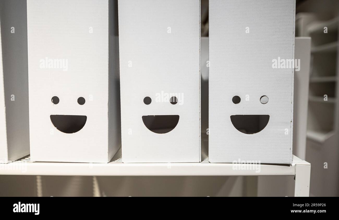 Document folders with cut out resembling smiley faces Stock Photo - Alamy