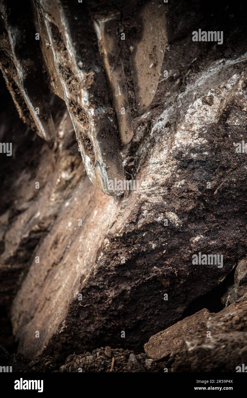 Teeth of a excavator scratching a stone Stock Photo - Alamy
